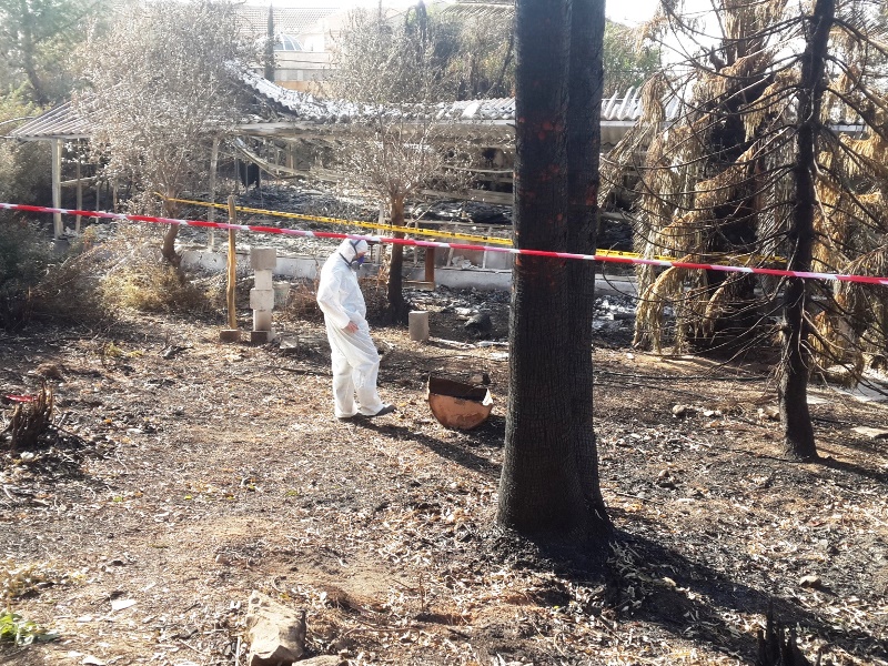Professionals remove asbestos from homes after a fire in Bet Meir in 2016