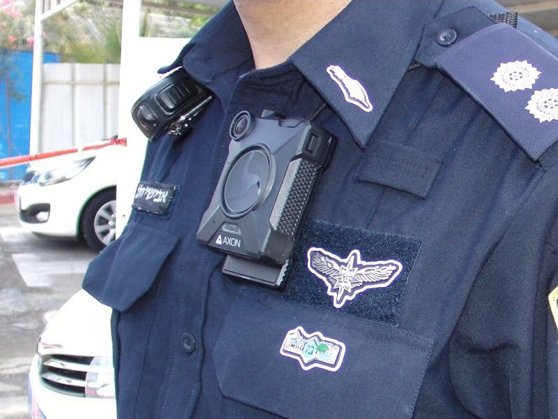 Police officer wearing body camera (illustration)